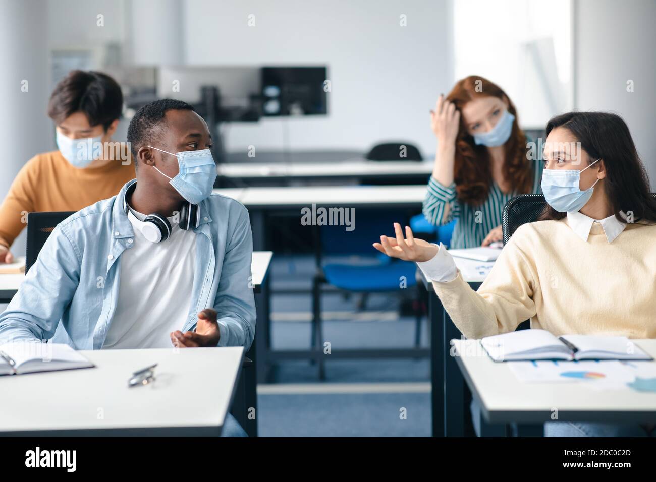 International students wearing medical masks and talking Stock Photo ...