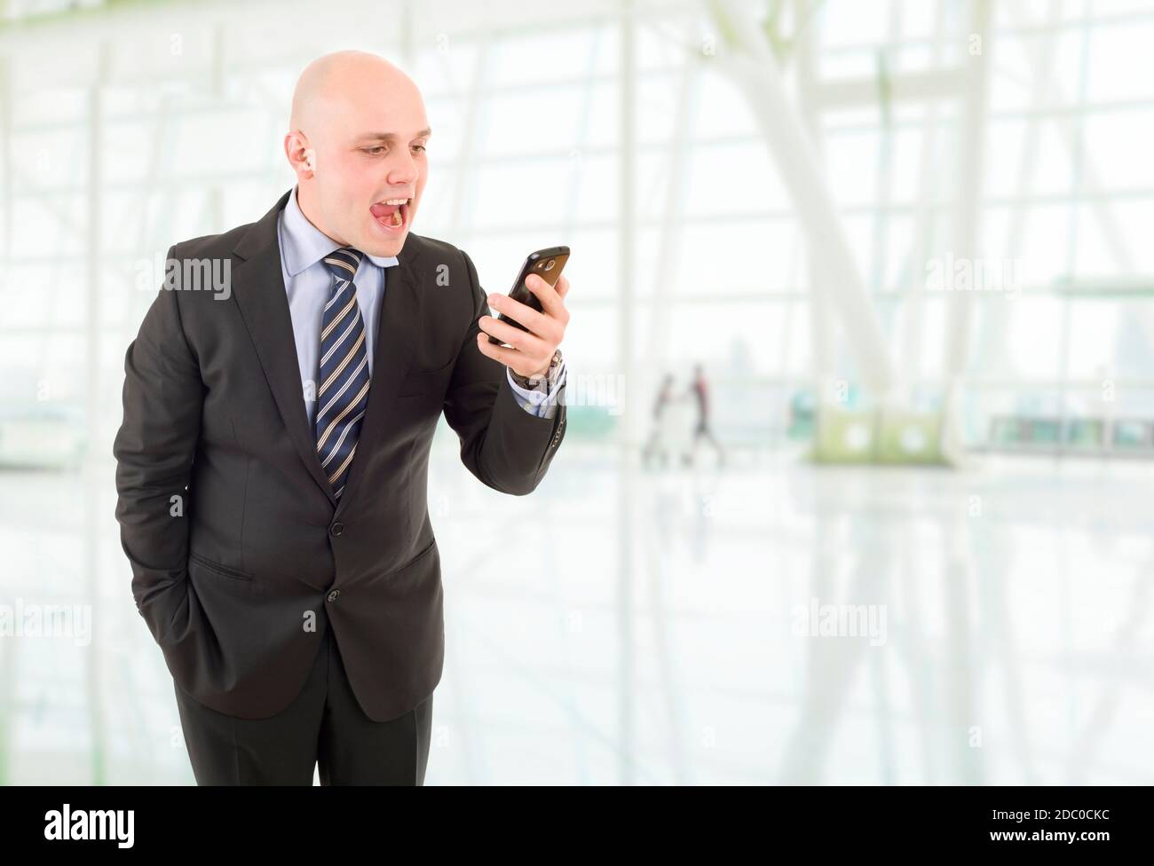 Angry businessman yelling into a cellphone, at the office Stock Photo ...