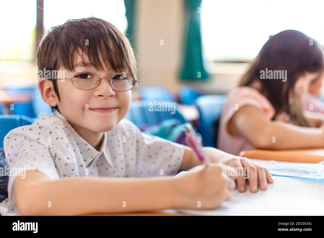 happy little boy studying in the classroom Stock Photo - Alamy