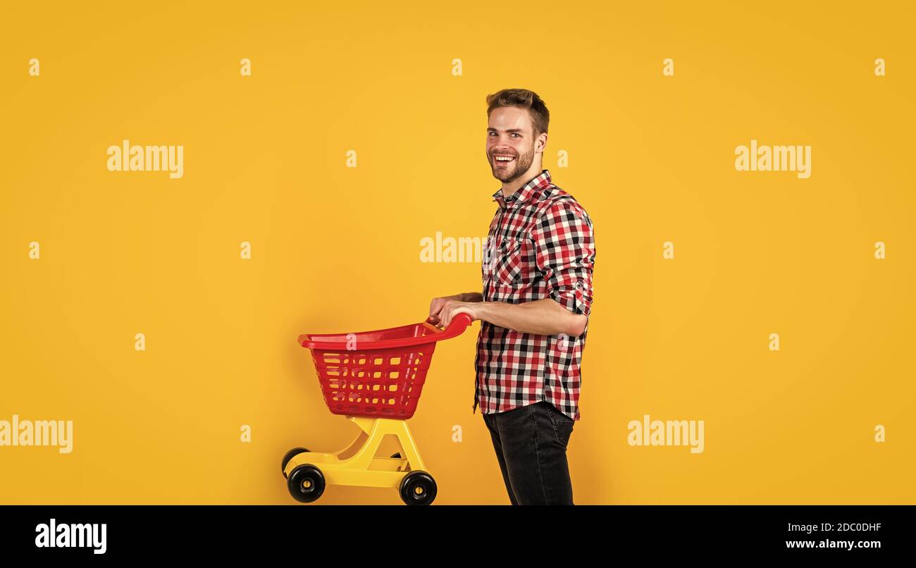 man go shopping. funny man with small shopping cart. weekend on buying ...