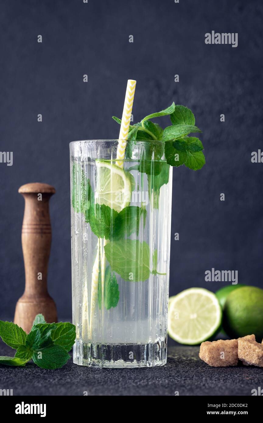 Glass of mojito cocktail with ingredients on dark background Stock ...