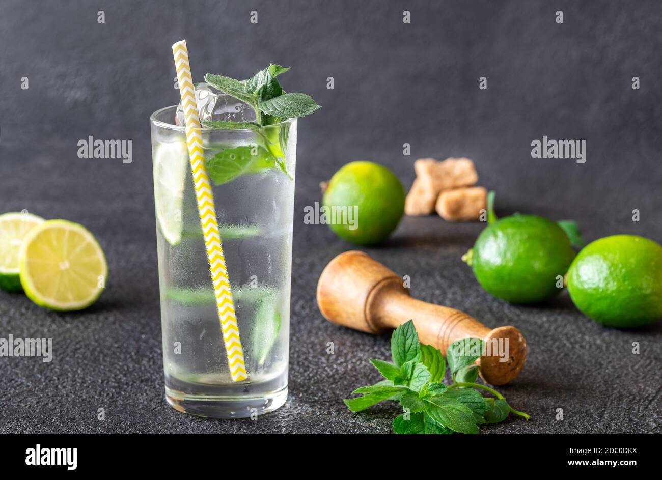 Glass of mojito cocktail with ingredients on dark background Stock ...
