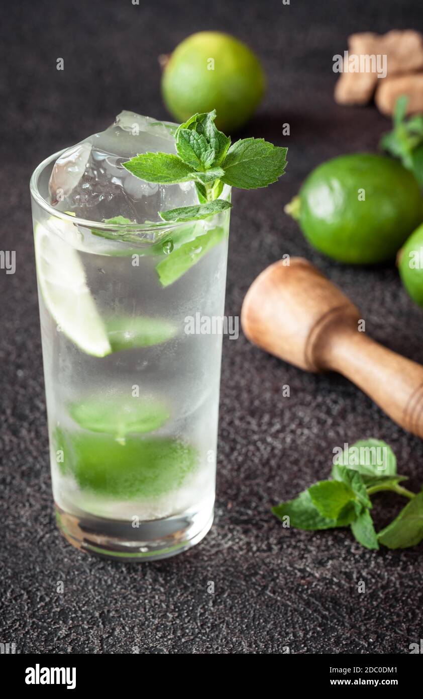 Glass of mojito cocktail with ingredients on dark background Stock ...
