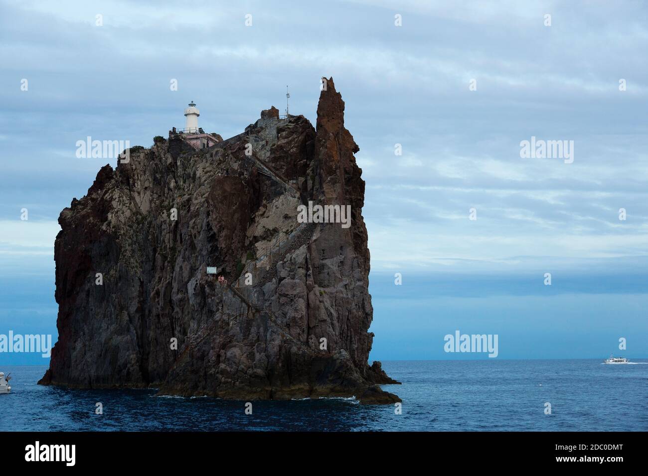 Sicily, Italy. The Strombolicchio Lighthouse sits on top of a volcanic ...