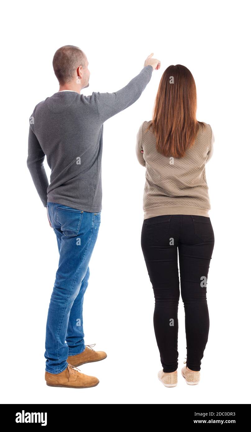 Back view of couple in sweater pointing. Rear view people collection ...