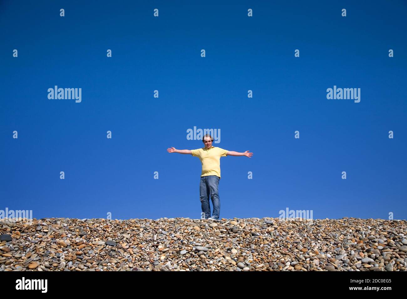 man with arms wide open at the beach Stock Photo - Alamy