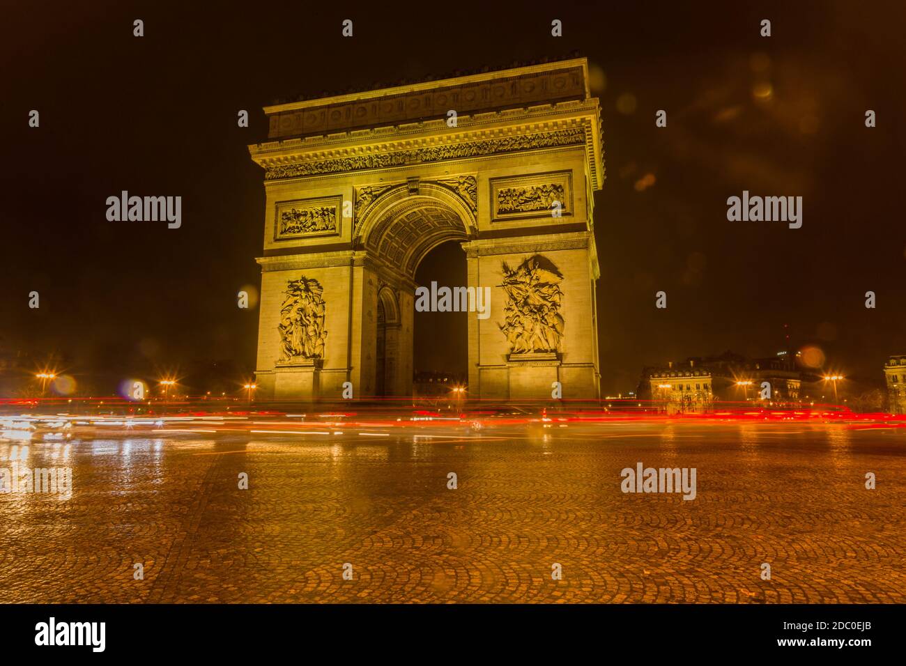 Paris triumphal arch illuminated at night, with car light trails Stock ...