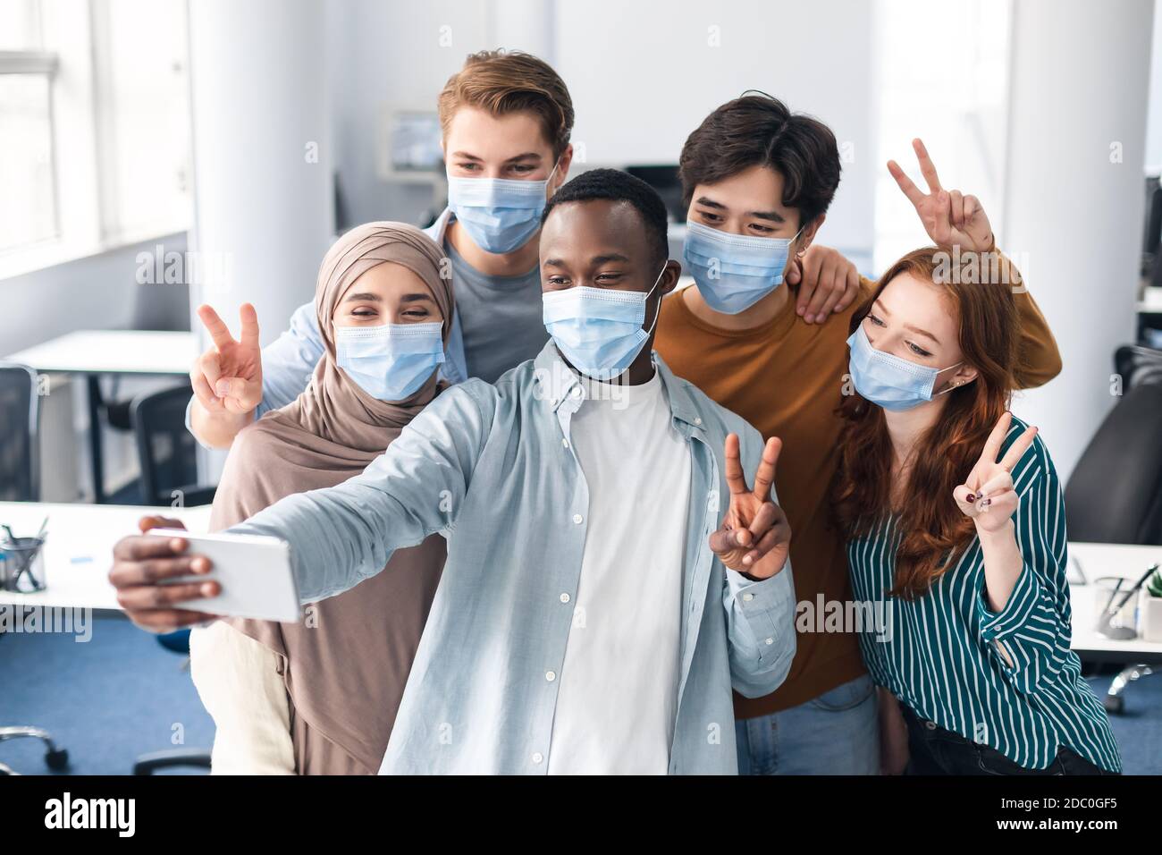 International students wearing medical face masks taking selfie Stock ...