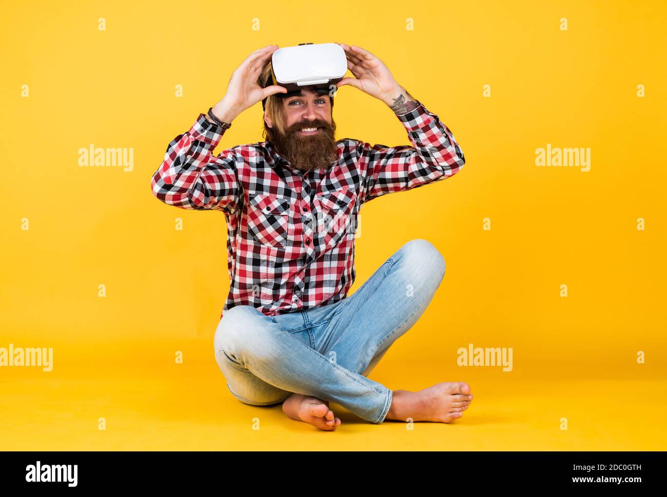 man wear wireless VR glasses. guy in VR headset. bearded hipster use ...