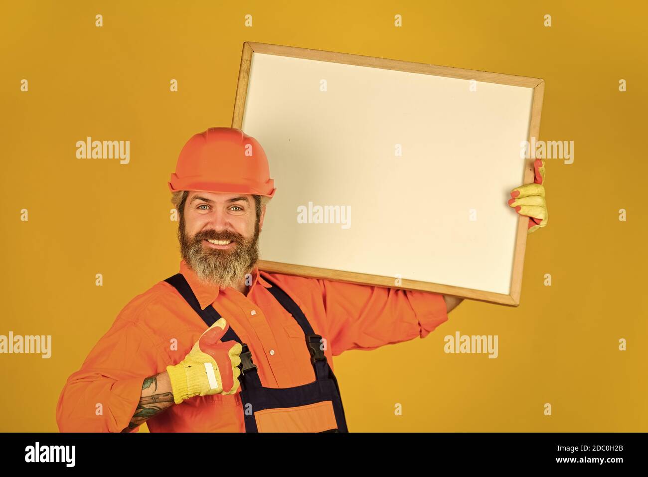 presenting flip-chart at meeting. male construction worker. copy space ...