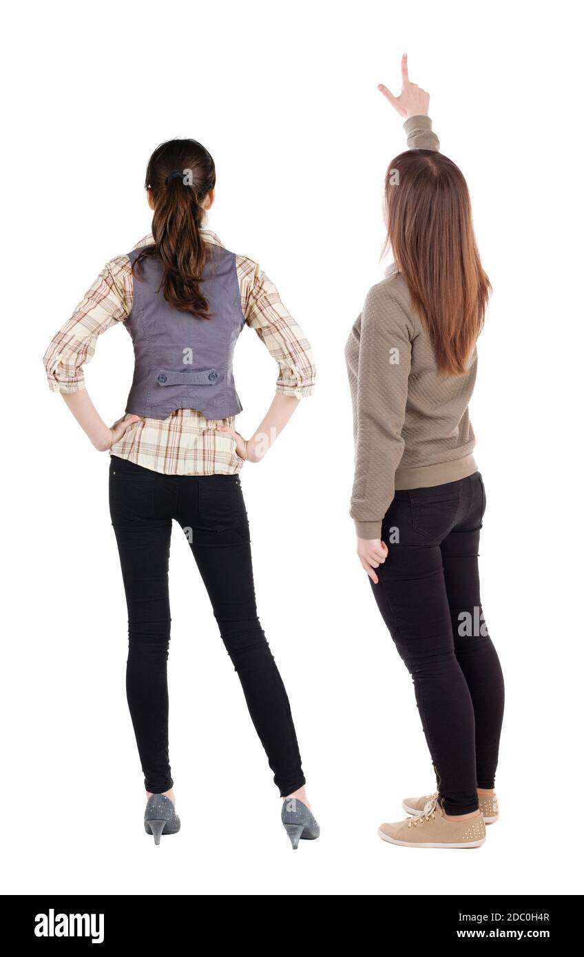 Back view of two young woman photographed on a mobile phone in sweater ...