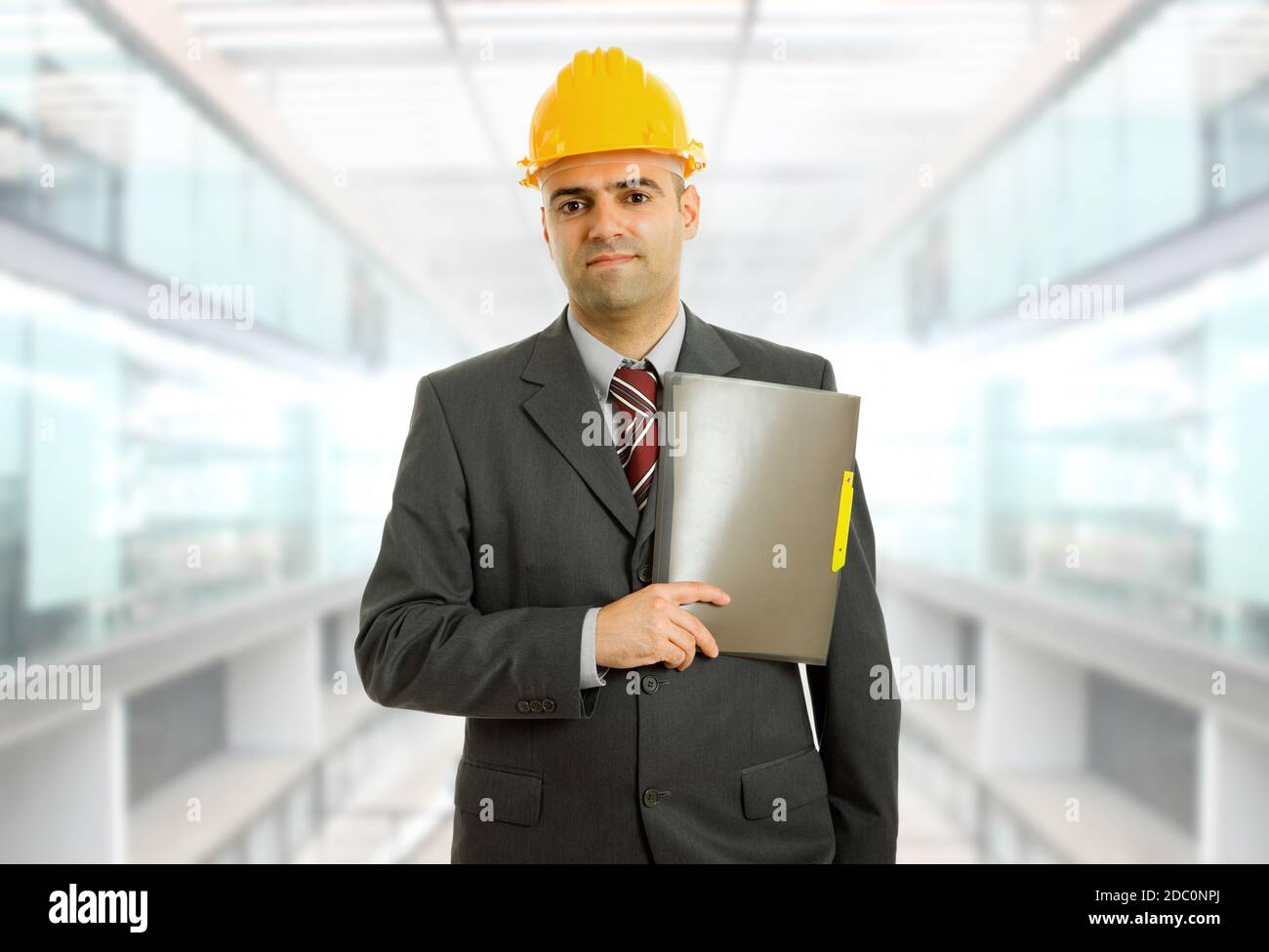 An engineer with yellow hat at the office Stock Photo - Alamy