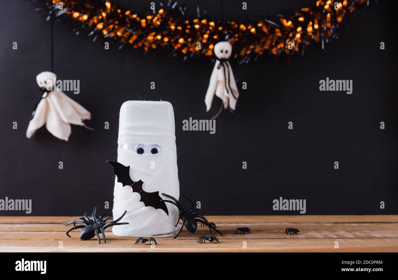 Funny Halloween day decor party concept, The mummy ghost on water glass ...