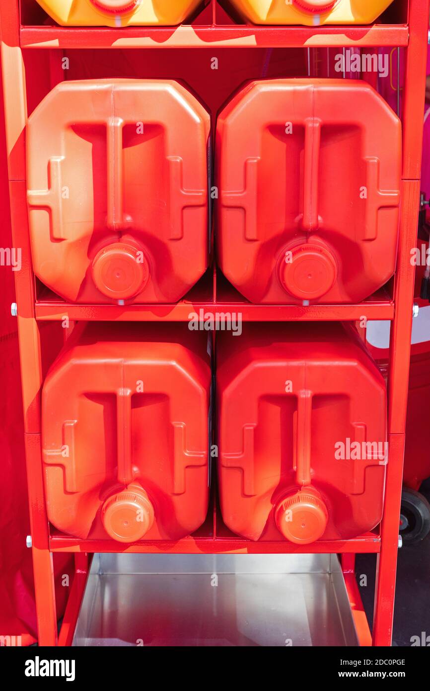 Big Red Plastic Cans at Storage Rack Stock Photo - Alamy