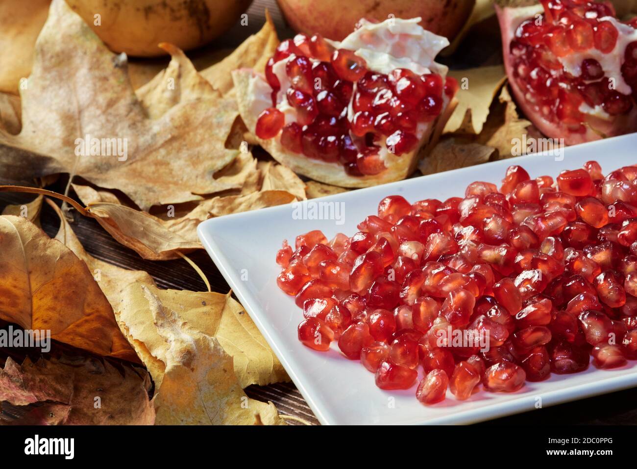 closeup of red seeds of the pomegranate fruit prepared on a plate ready ...