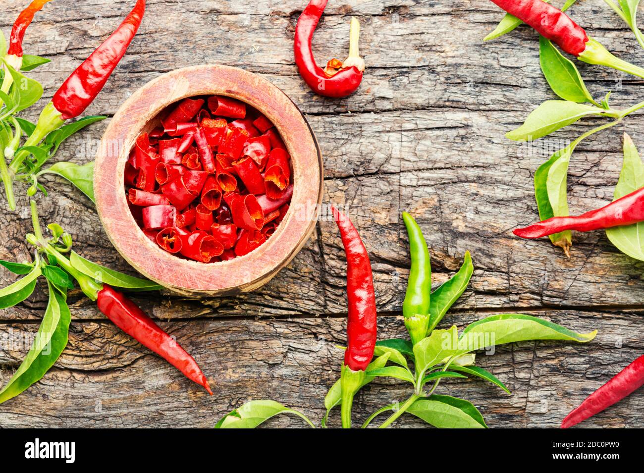 Sliced red hot chili peppers on on wooden background Stock Photo - Alamy