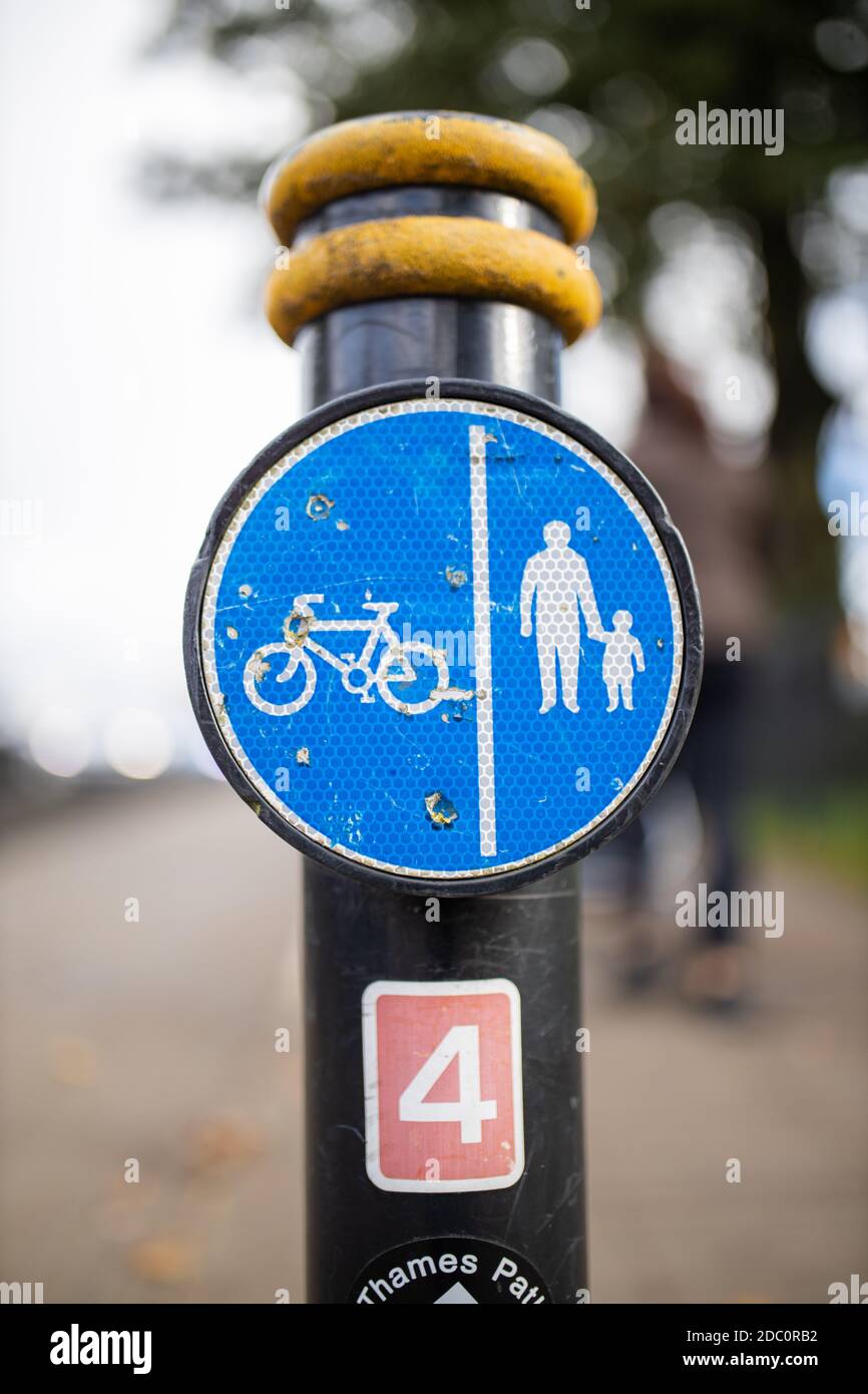 Blue sign on a pole indicating the pedestrians and cyclists paths Stock ...