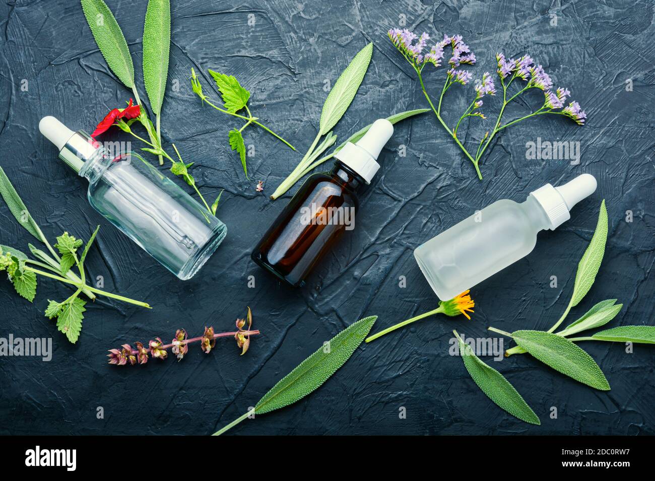 Bottles of tincture and healthy herbs and flowers.Alternative healthy ...