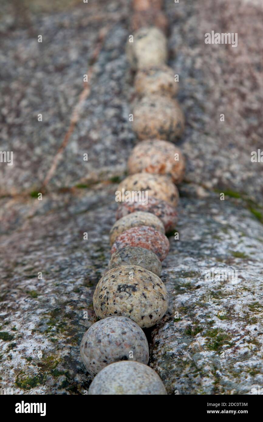 Nature Art with a long line of round pebble, created at Porth Nanven ...