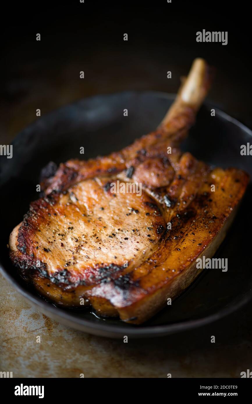close up of huge rustic pan fried pork chop Stock Photo - Alamy