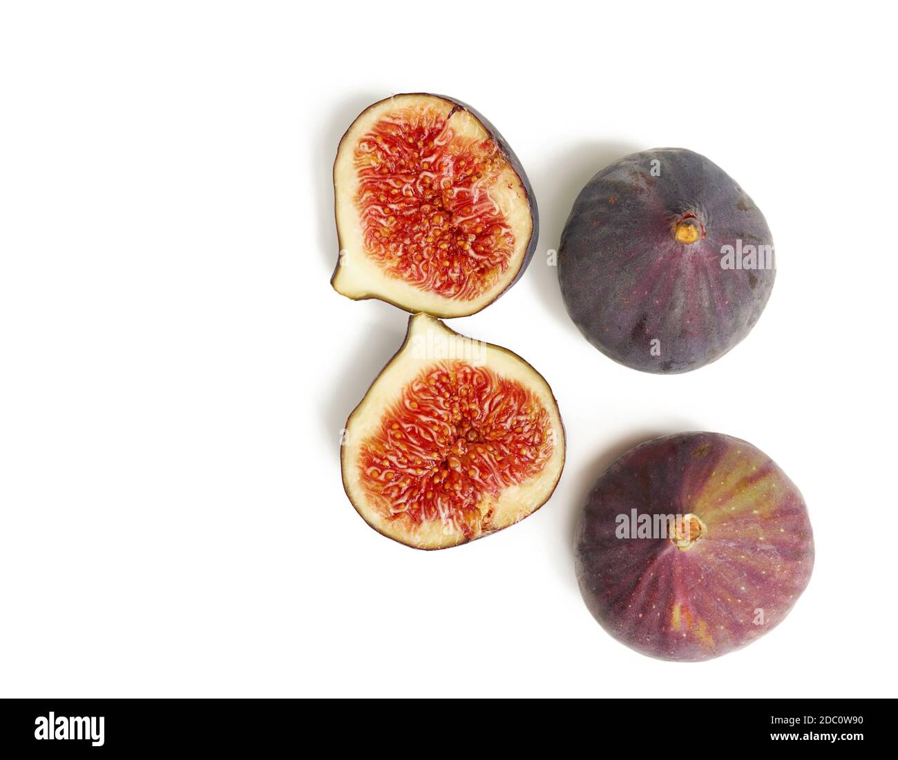 ripe whole and halved purple figs isolated on white background, top ...