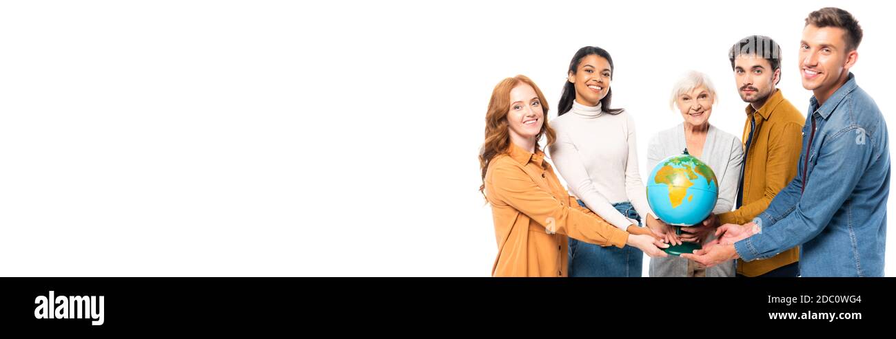 Multicultural people smiling at camera while holding globe together ...