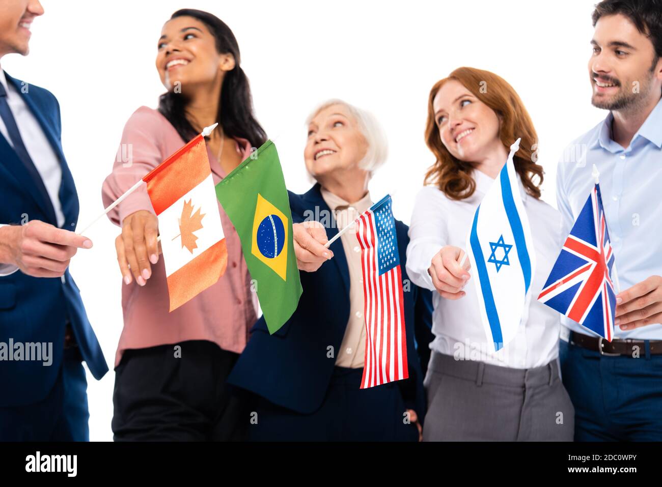 Flags of countries in hands of multiethnic businesspeople on burred ...