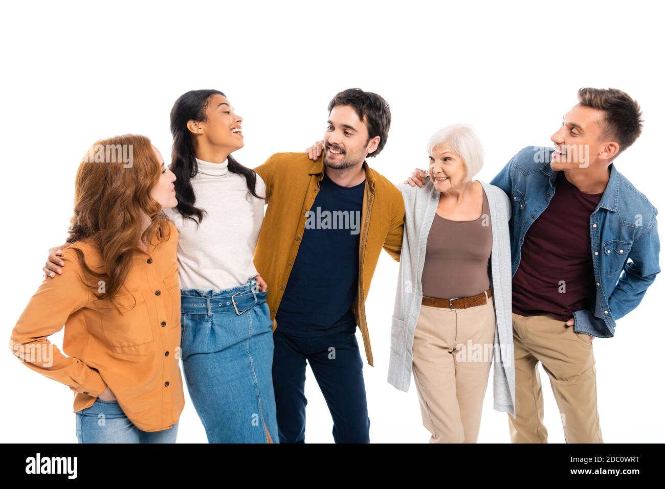 Smiling multicultural people looking at each other while hugging ...