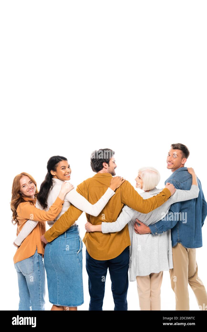 Multicultural friends smiling while hugging each other isolated on ...