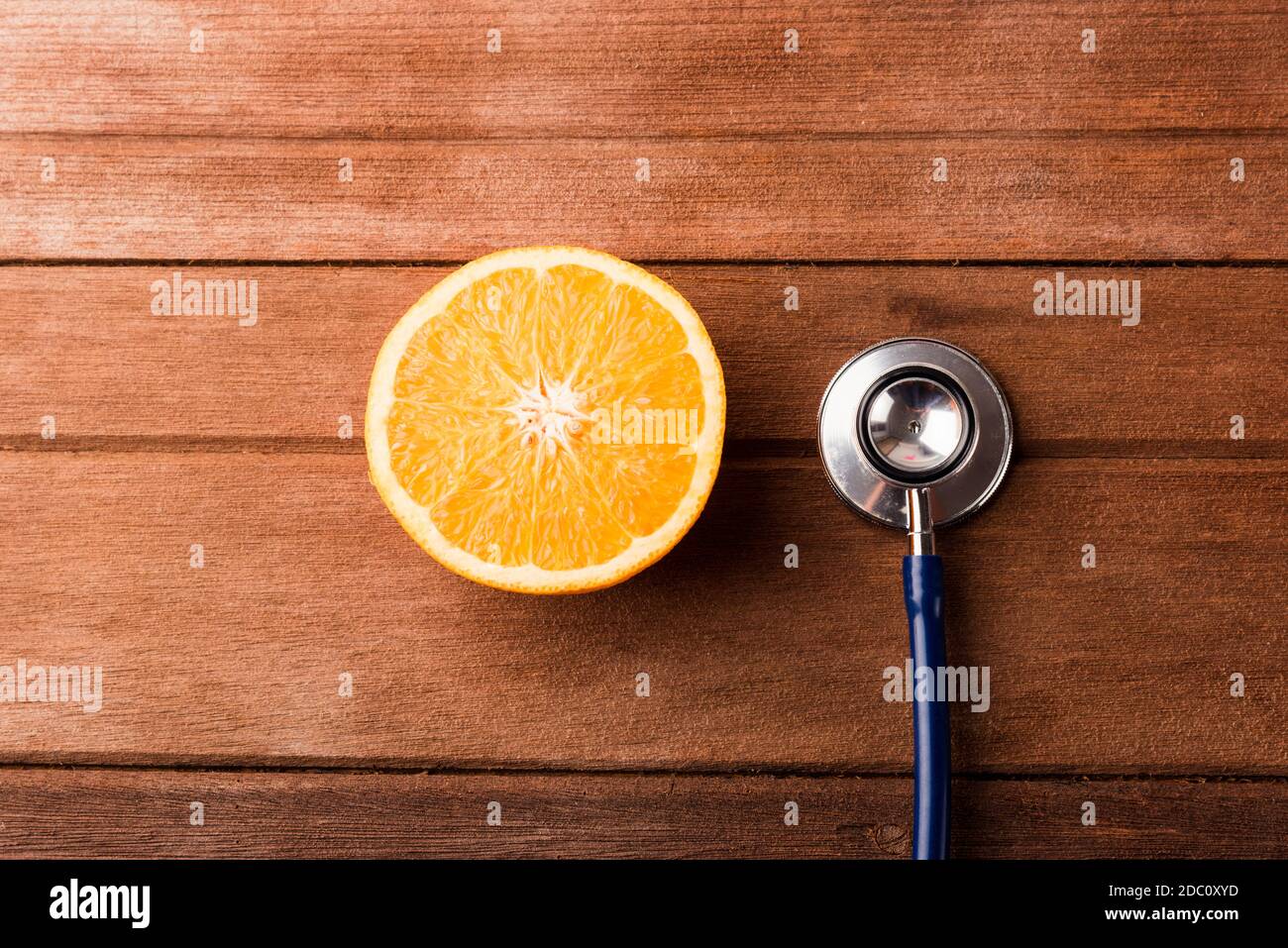 Orange fruit and Doctor stethoscope on wooden table, Vitamin C, Healthy ...