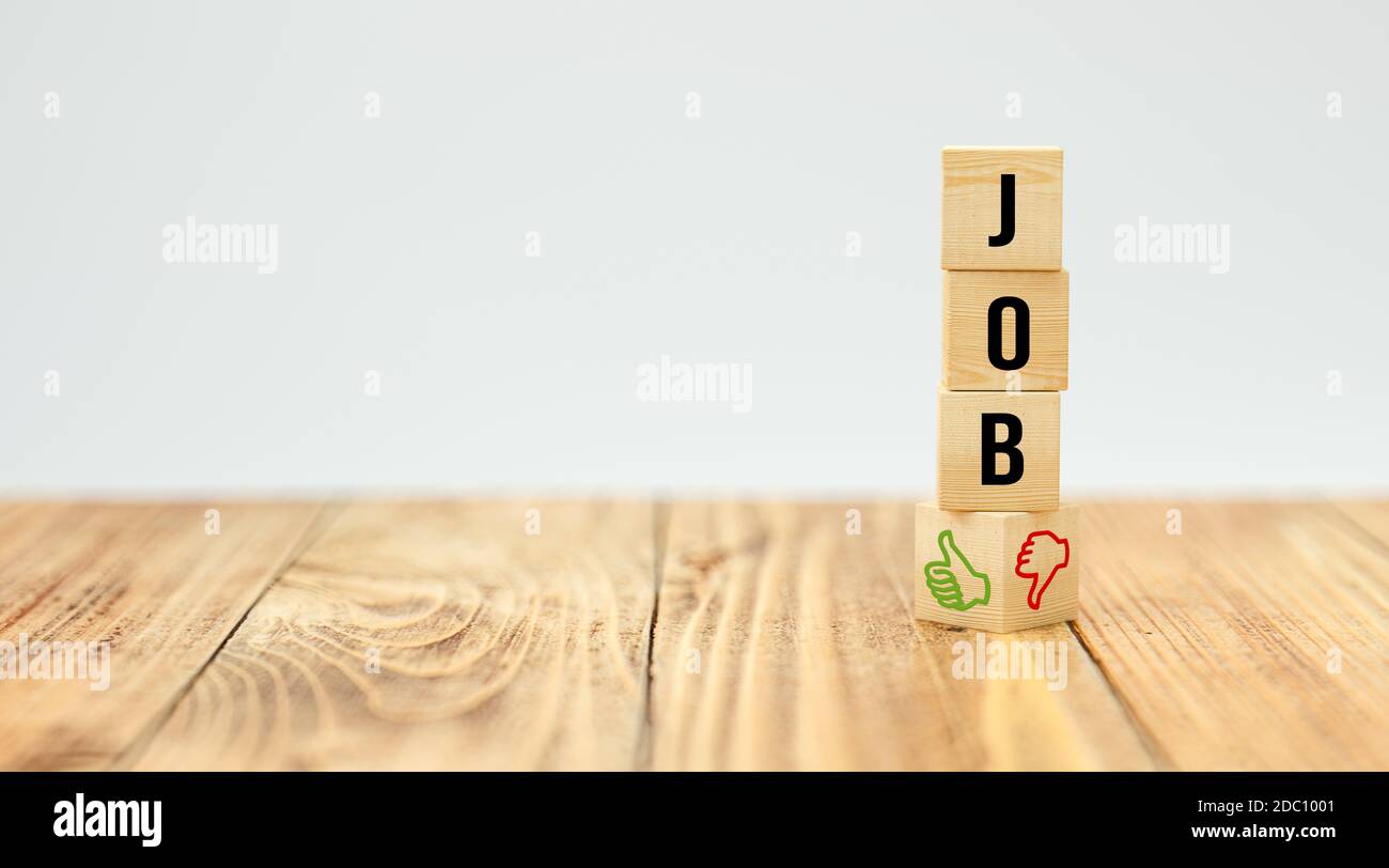 cubes with the word JOB and thumbs-up and thumbs-down icons on wooden ...