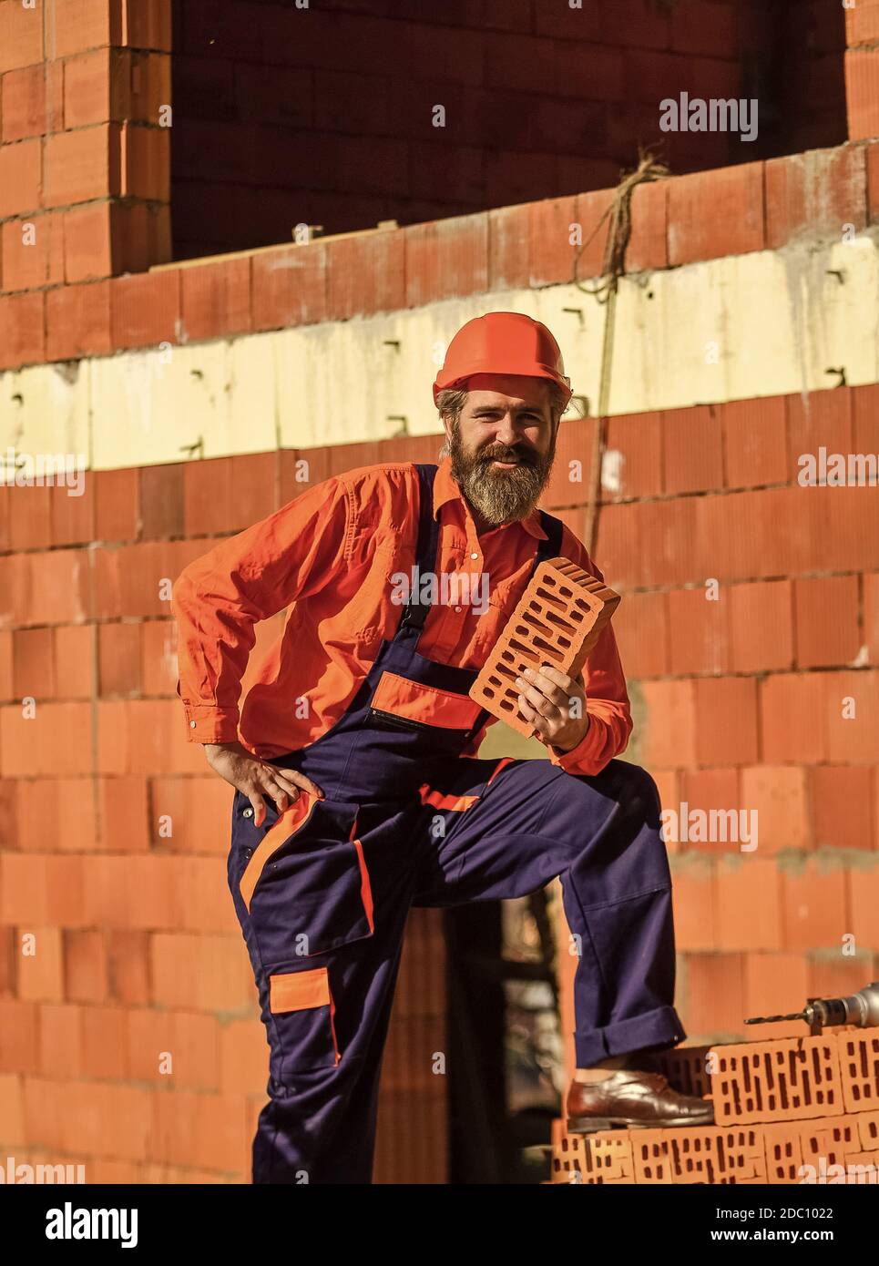build your own future. happy bearded man hold brick. brickwork. Man ...