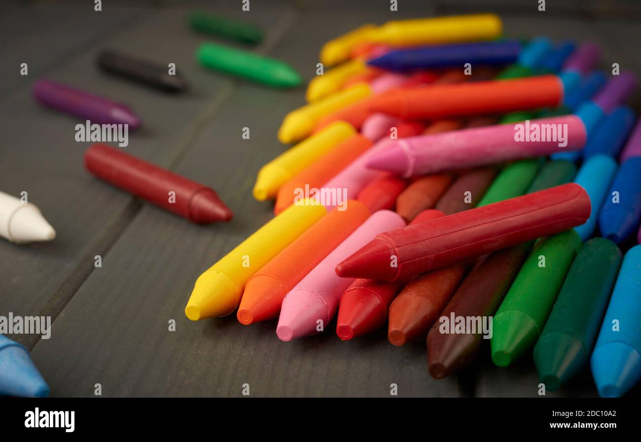 Colored wax crayons used by children in school on gray wood Stock Photo ...