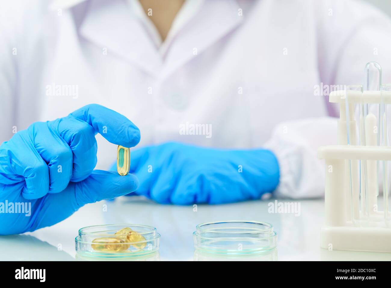 Close up Scientist hands putting in nitrile blue latex gloves holding ...