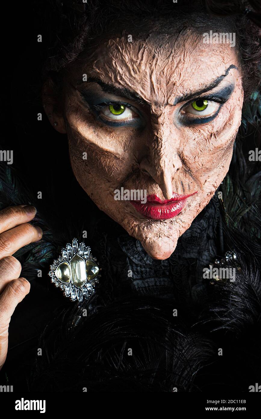 Scary dark witch looking at camera Stock Photo - Alamy