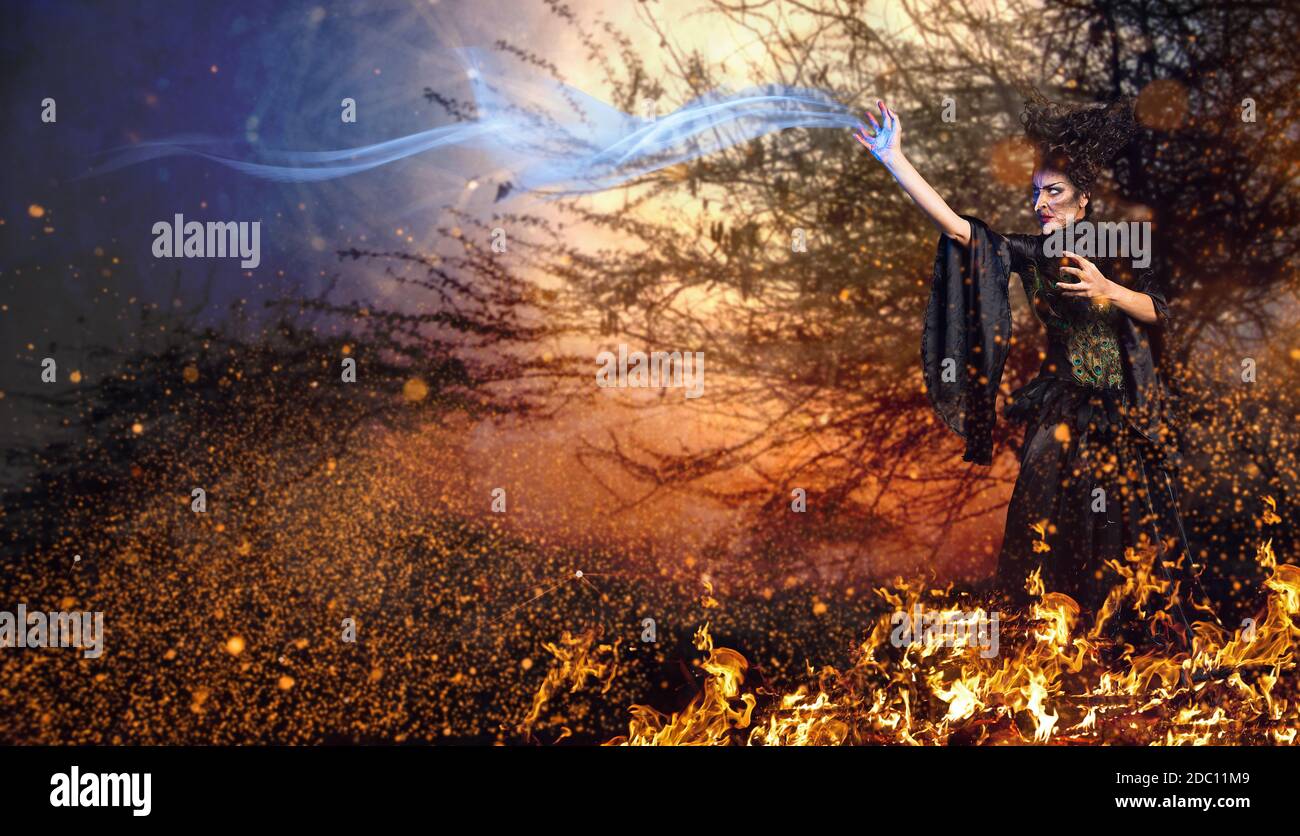 Scary witch conjuring a spell in the woods Stock Photo - Alamy