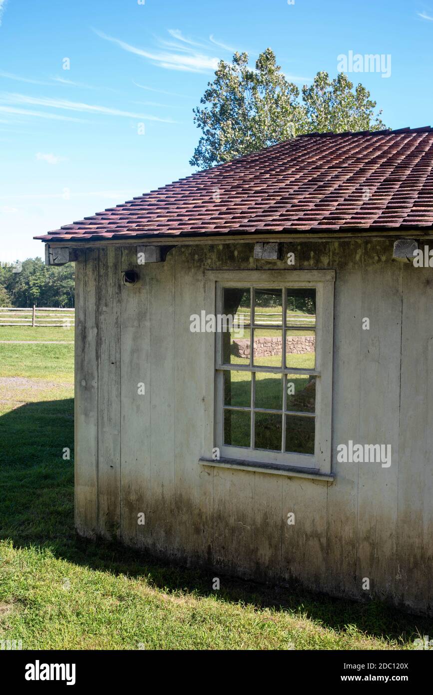 Whitewashed building at the idyllic colonial village, green pasture is ...