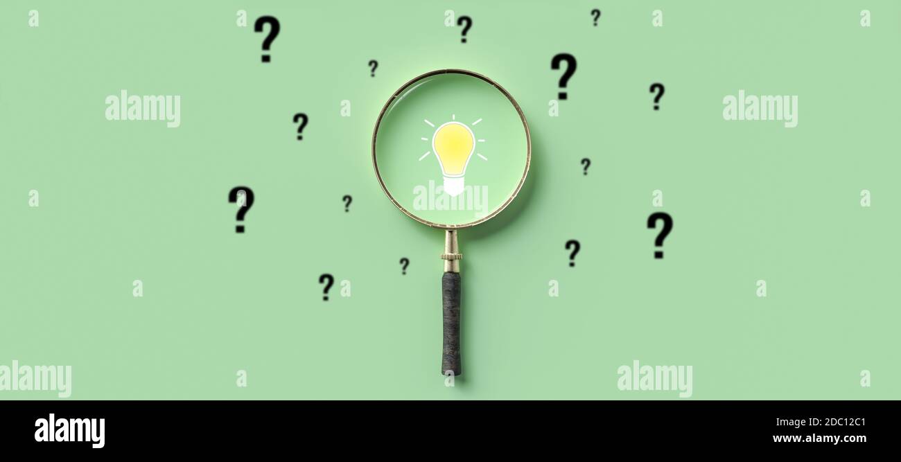 magnifying glass with lightbulb as symbol for finding a solution on ...