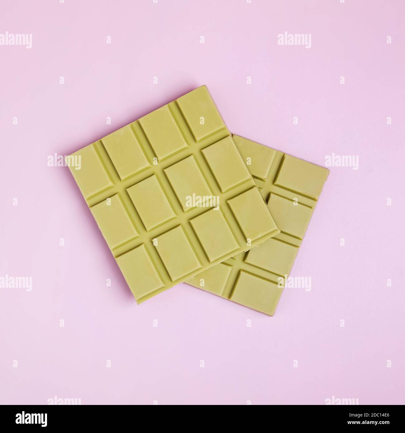 Square bars of milk chocolate of green color Stock Photo - Alamy