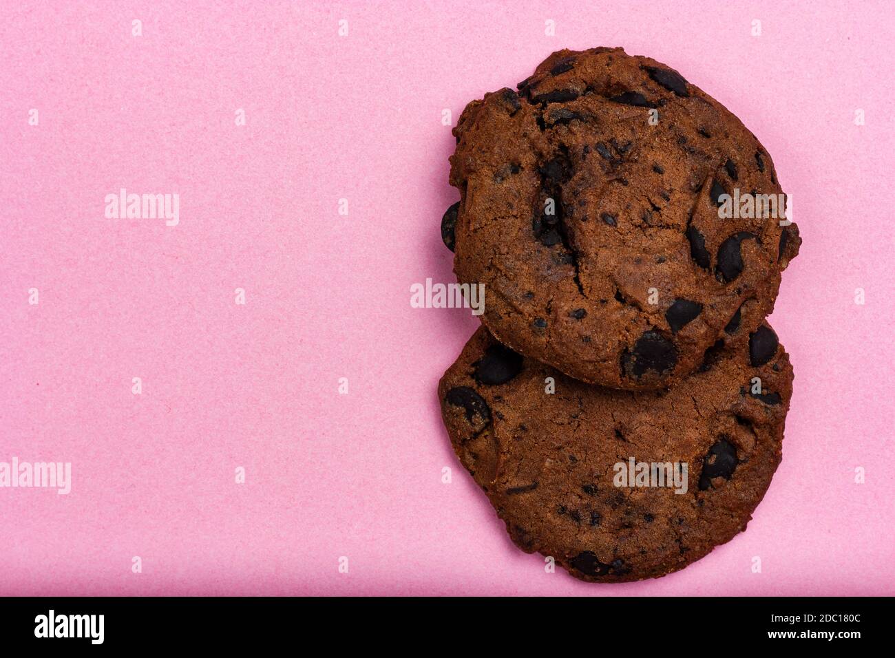 Cookies with chocolate chips on a pink background. View from above ...