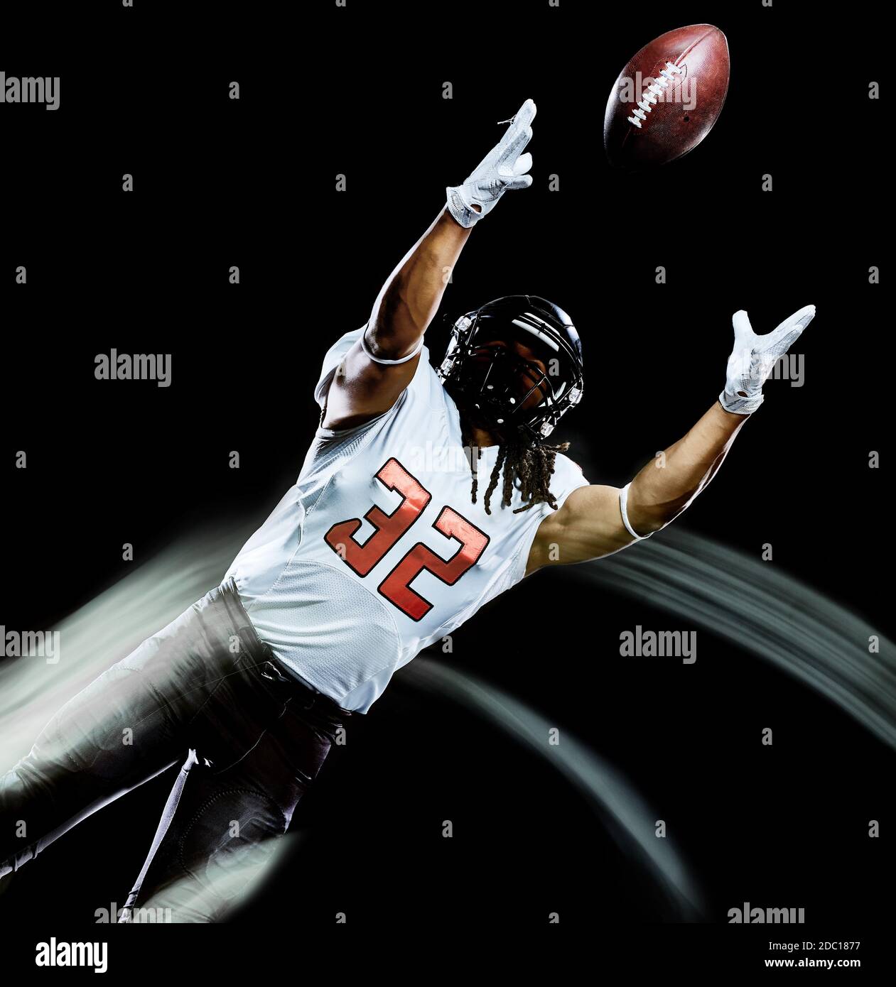 one african american football player man studio shot isolated on black ...