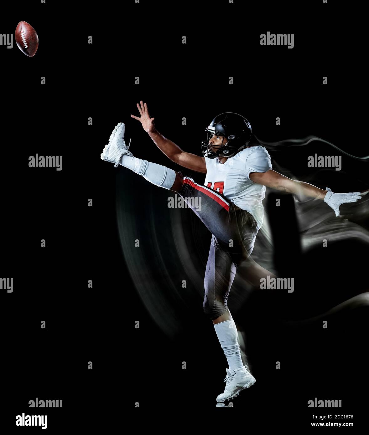 one african american football player man studio shot isolated on black ...
