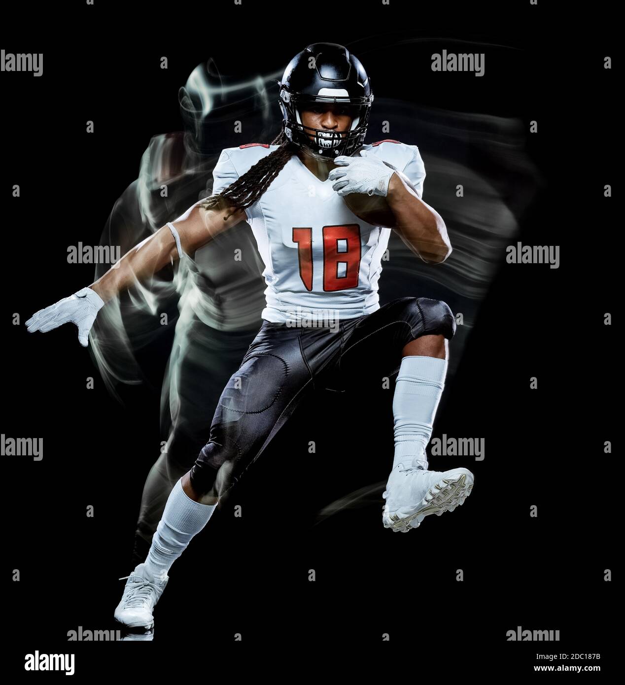 one african american football player man studio shot isolated on black ...