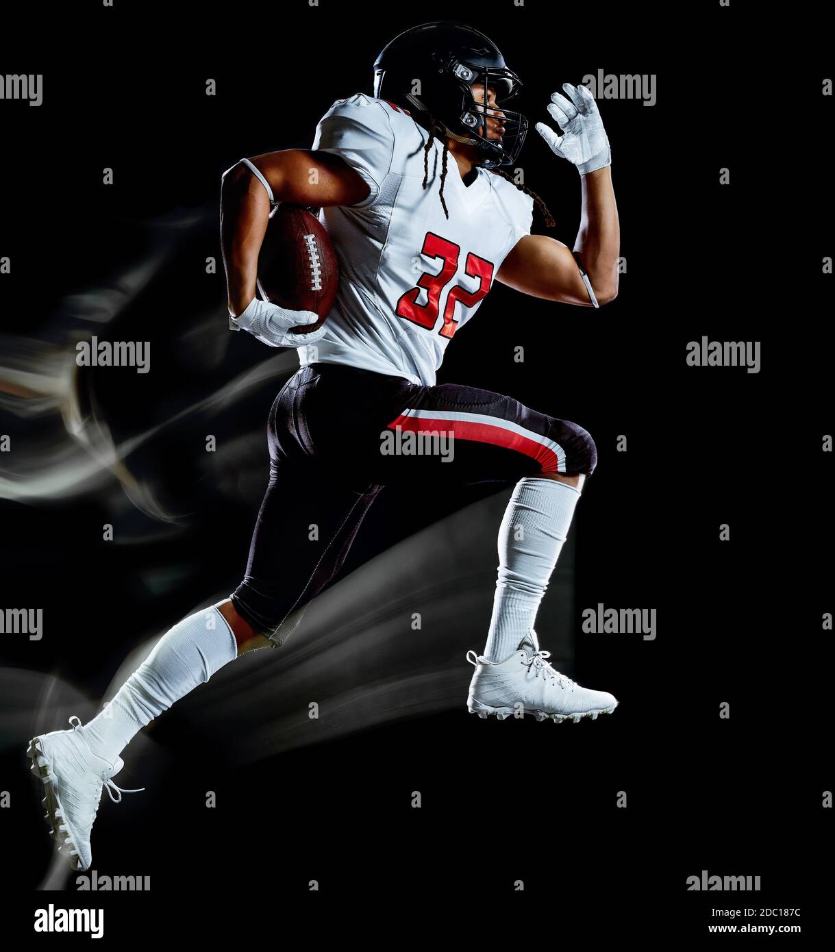 one african american football player man studio shot isolated on black ...