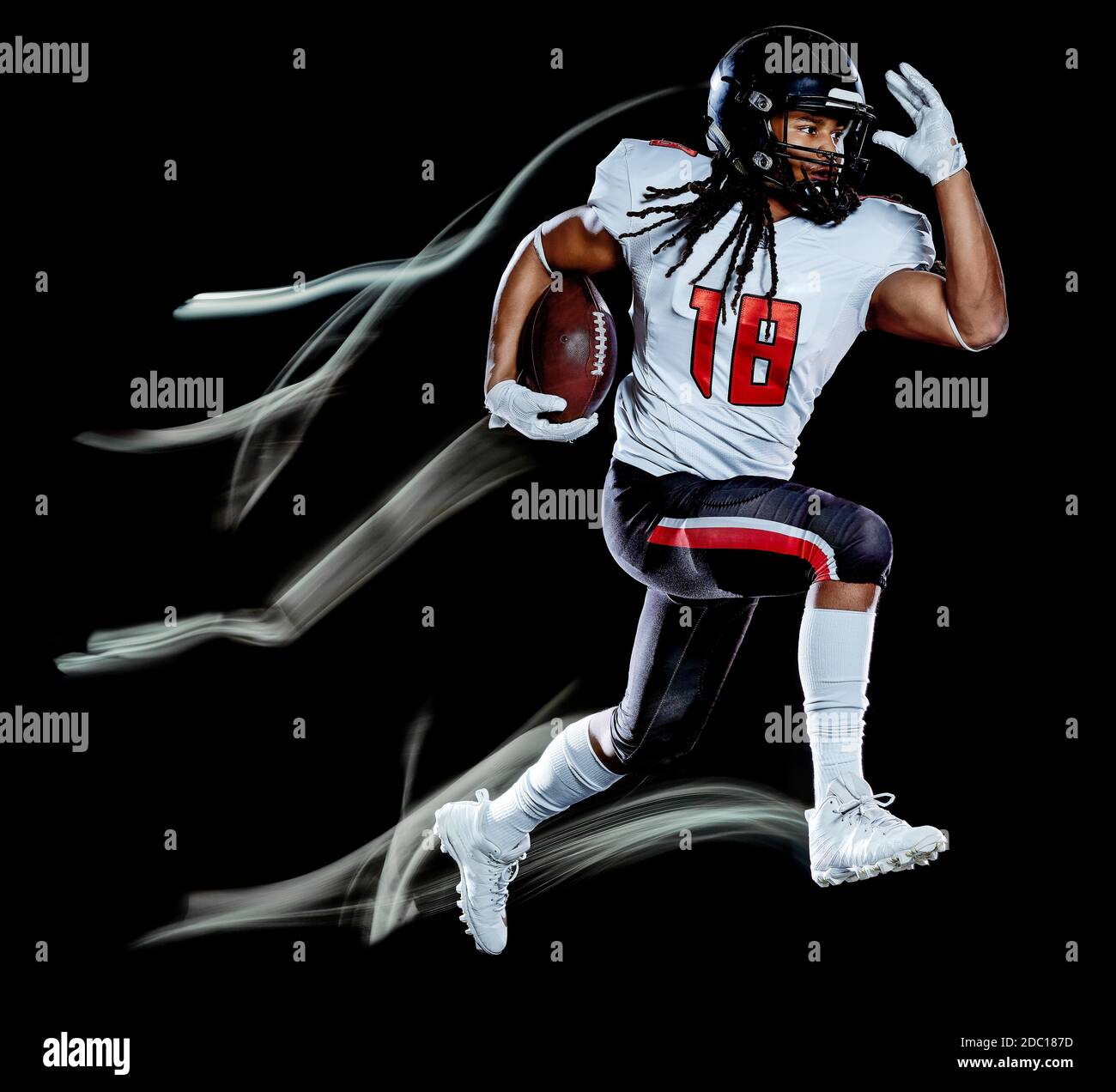 one african american football player man studio shot isolated on black ...