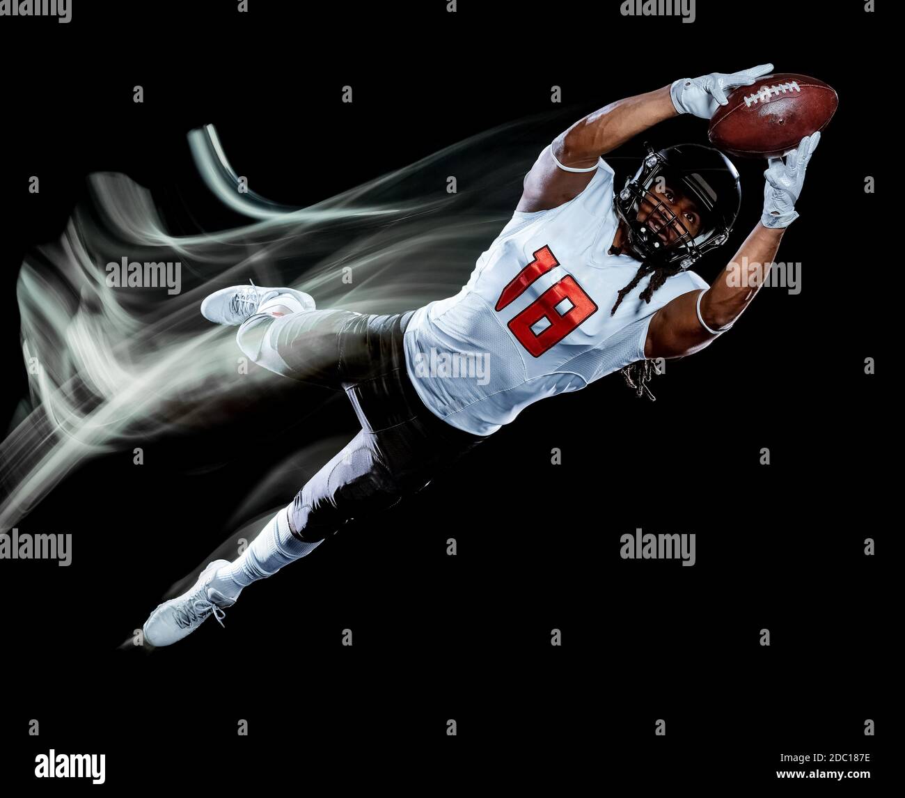 one african american football player man studio shot isolated on black ...