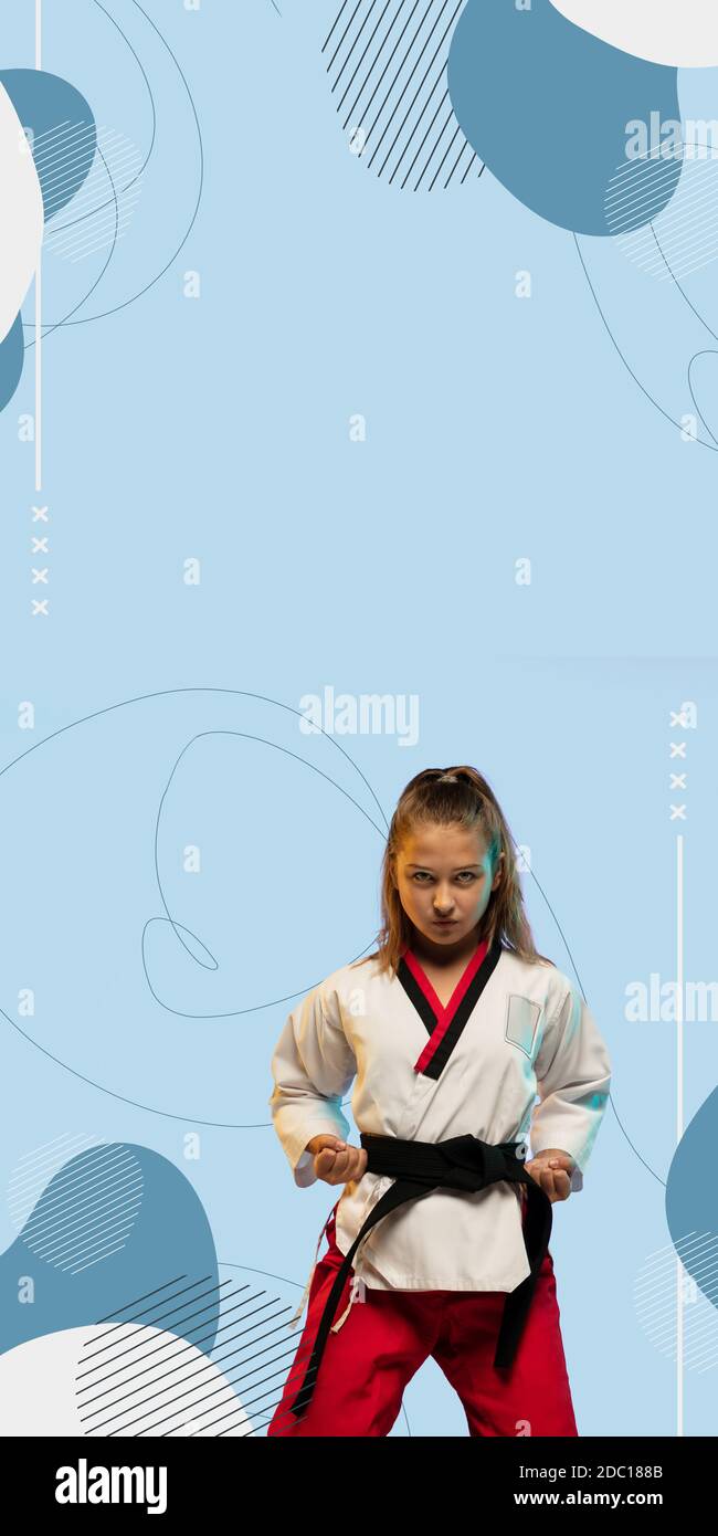 Karate, taekwondo girl with black belt isolated on blue background with ...