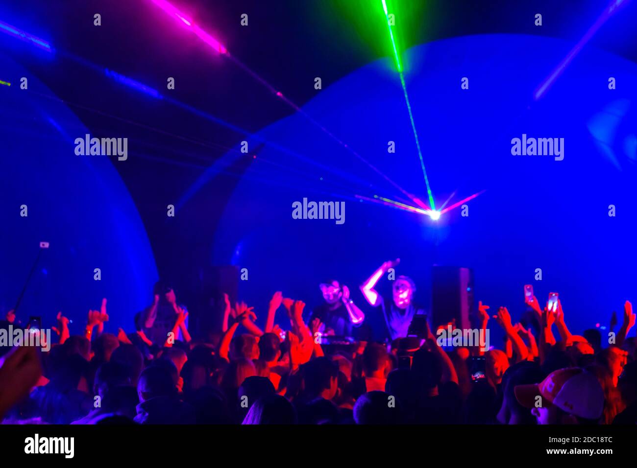 Crowd and DJs dancing during party Stock Photo - Alamy