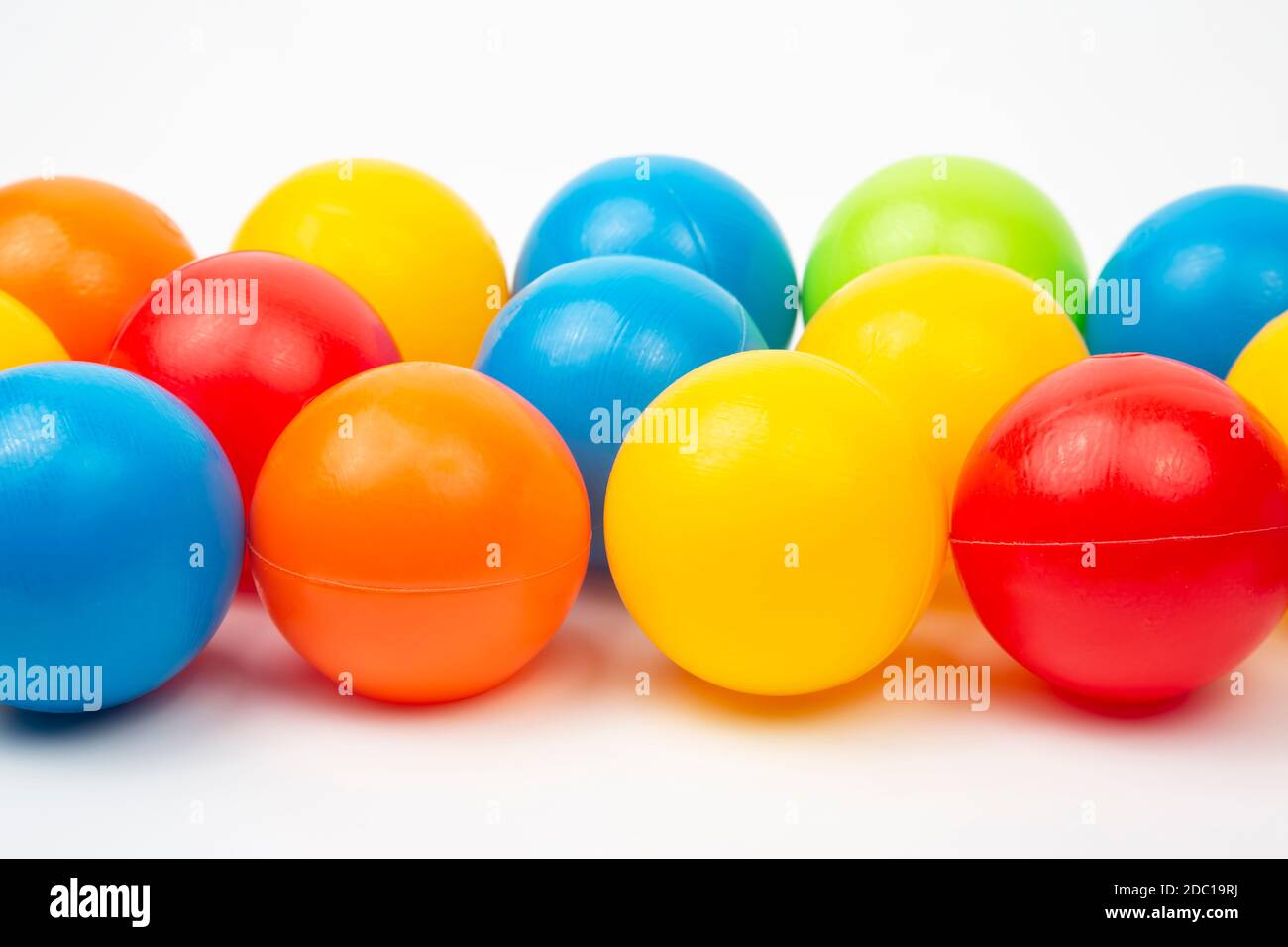 Colored plastic balls on white background. leisure and game items ...