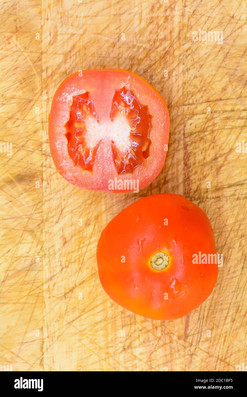 Close up tomato on the chopping board wood Stock Photo - Alamy